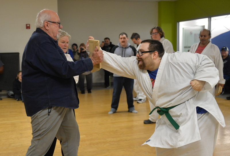 Matt Harvey breaks a board held by Ed Porter. (Paula Roberts photo ...
